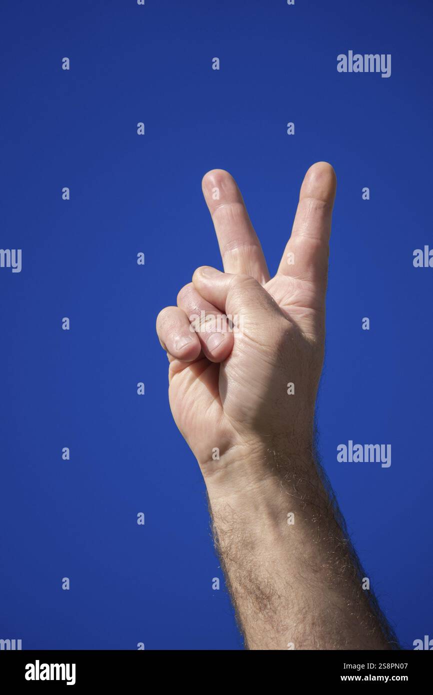 An image of a male hand V sign Stock Photo - Alamy