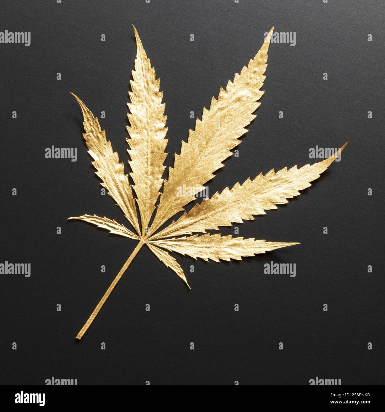 A golden Cannabis leaf symbol isolated on black Stock Photo - Alamy