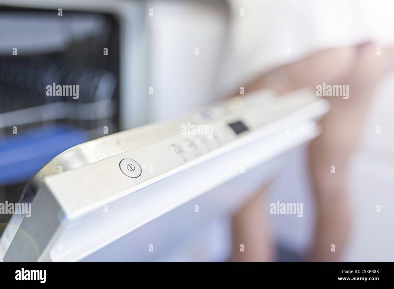 Side view of a dishwasher's open control panel near a person Stock ...