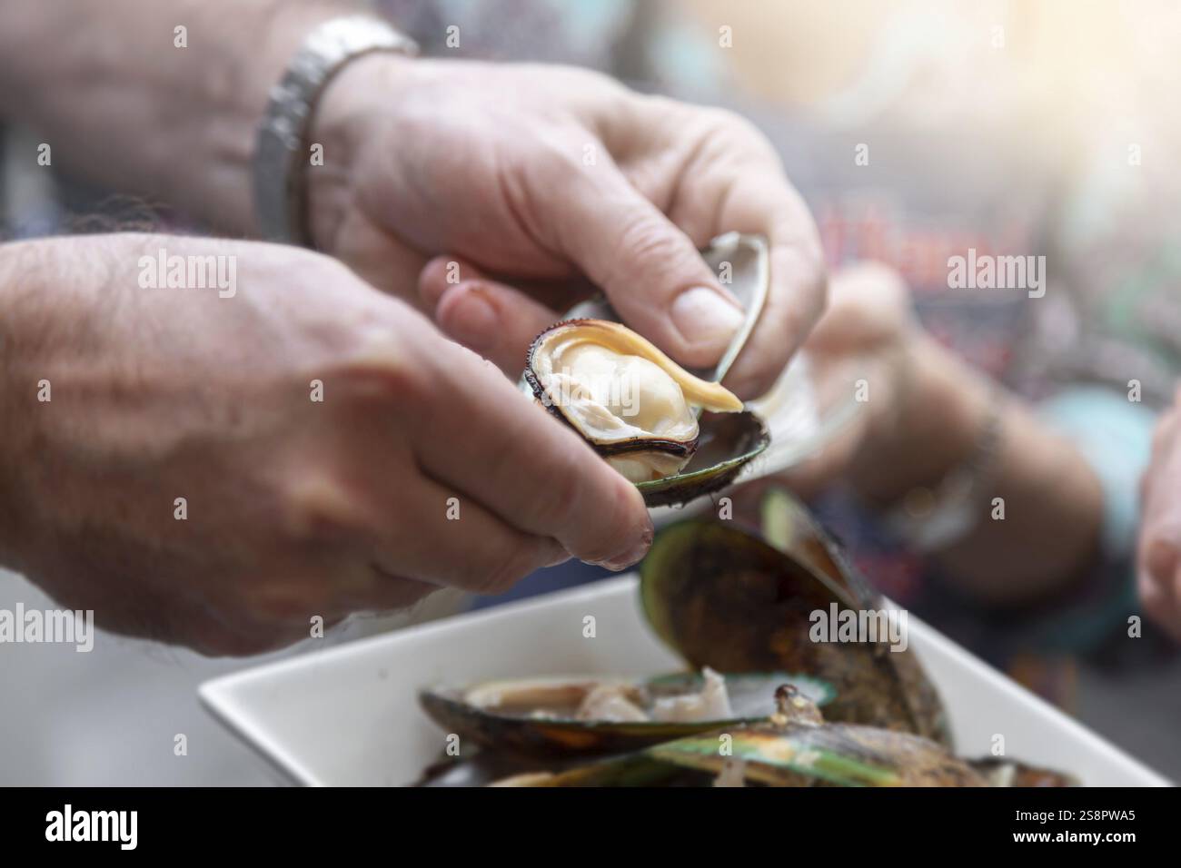 An image of eating mussel in New Zealand Stock Photo - Alamy