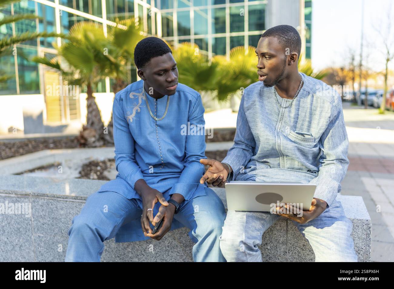 Two senegalese businessmen wearing traditional dashiki attire are ...