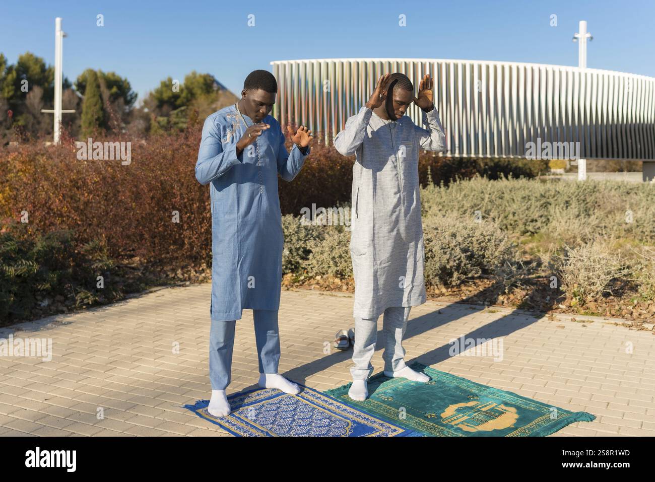 Two young senegalese men wearing traditional clothing are performing ...