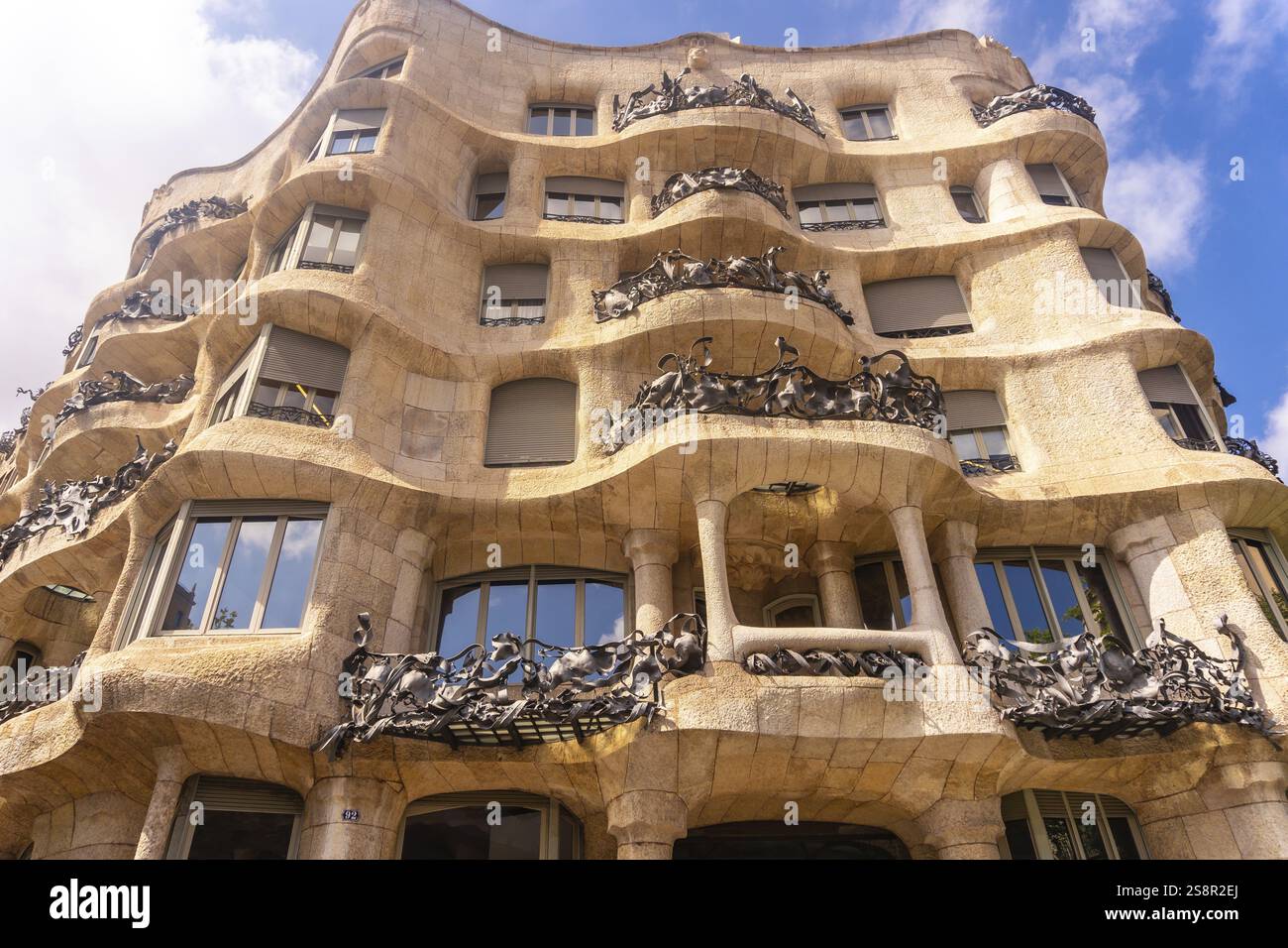 Wrought iron balconies and undulating facade of casa mila, a famous ...