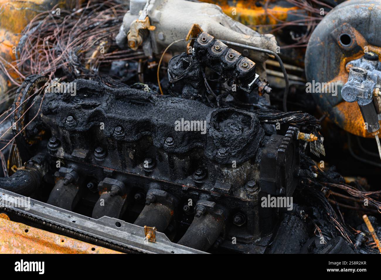 A close-up of the burnt-out engine compartment of a car. View from ...