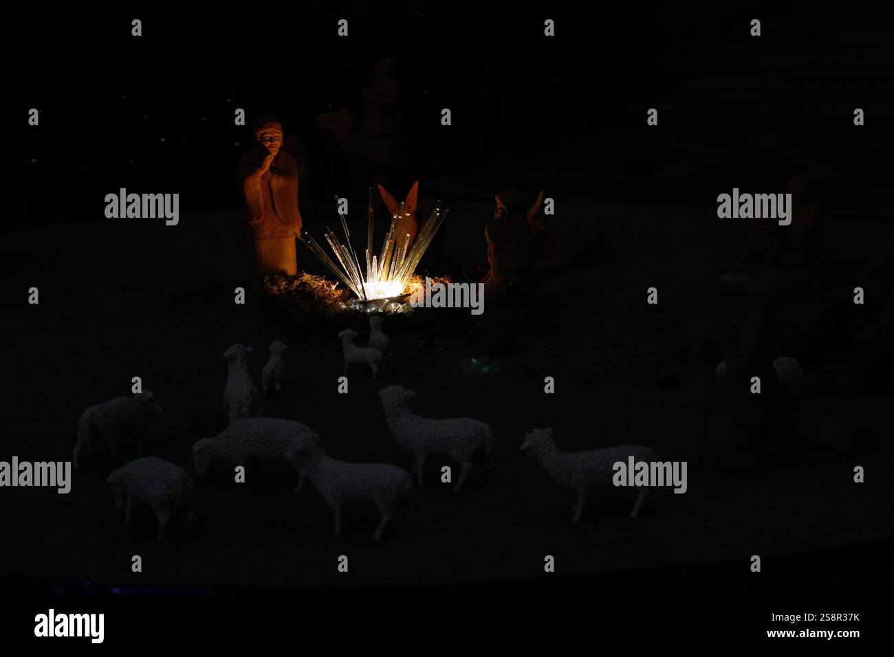 Illuminated Nativity Scene Featuring Figures and Sheep in a Dark ...