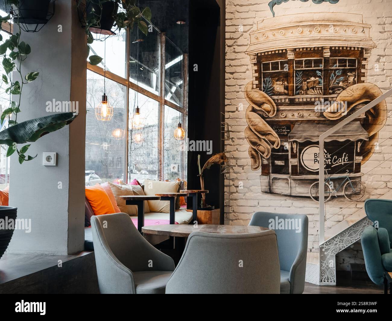 cafe interior with large windows and a second floor Stock Photo - Alamy