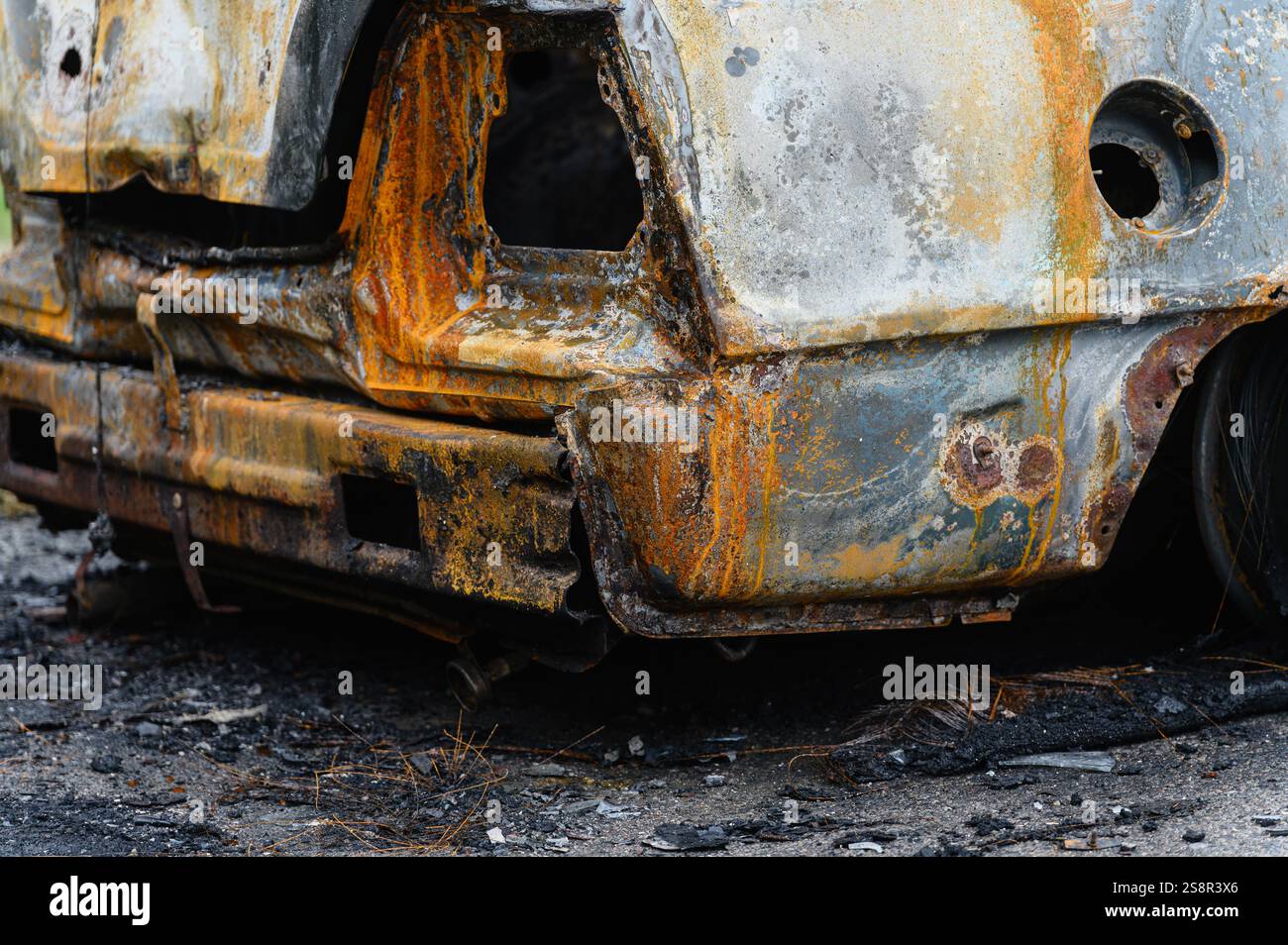 Burned car wreck abandoned on roadside in nature. Close-up of the trunk of a burnt-out car Stock ...