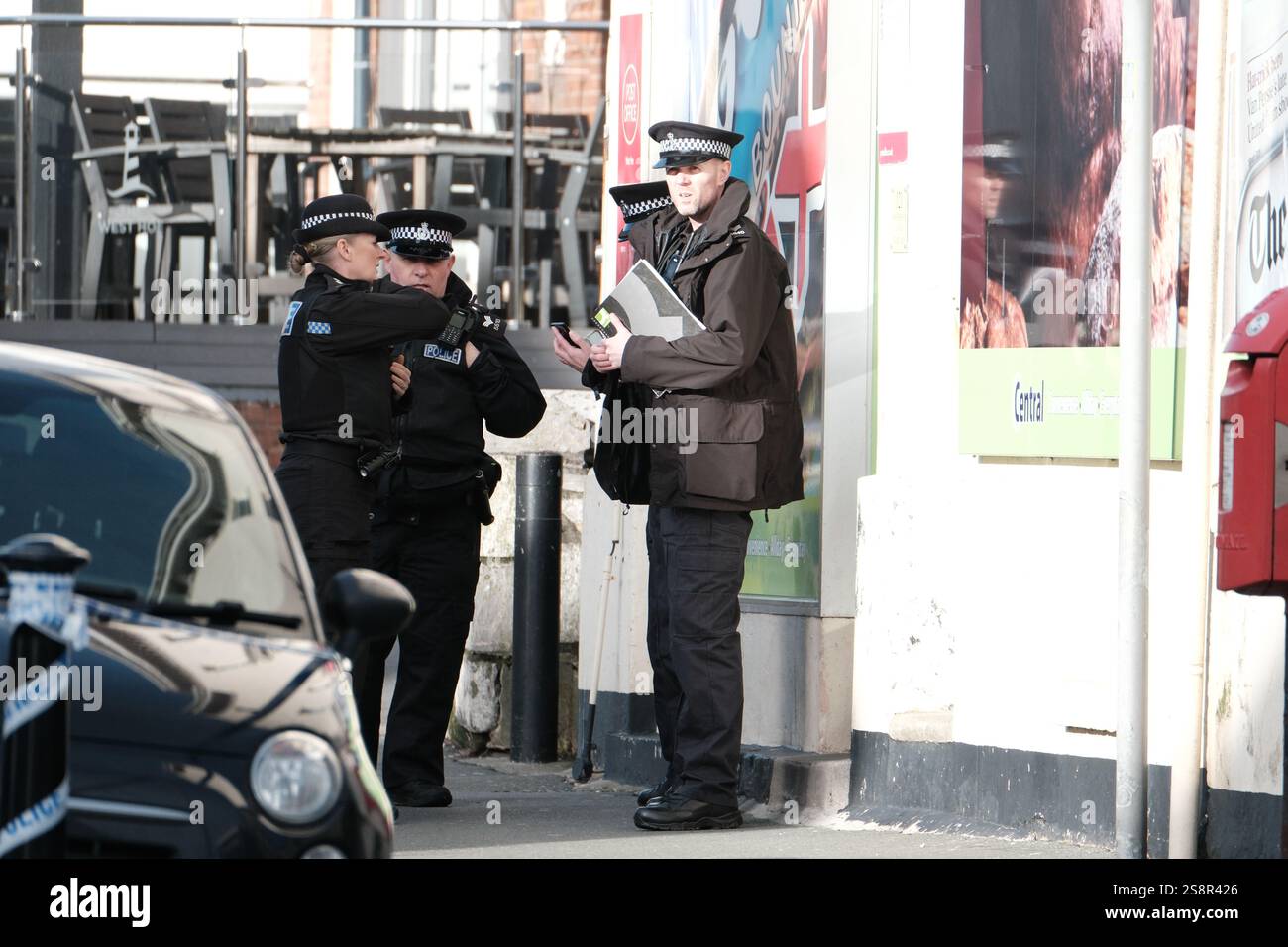 Police officers at a scene in Plymouth, Devon, where a manhunt is under ...