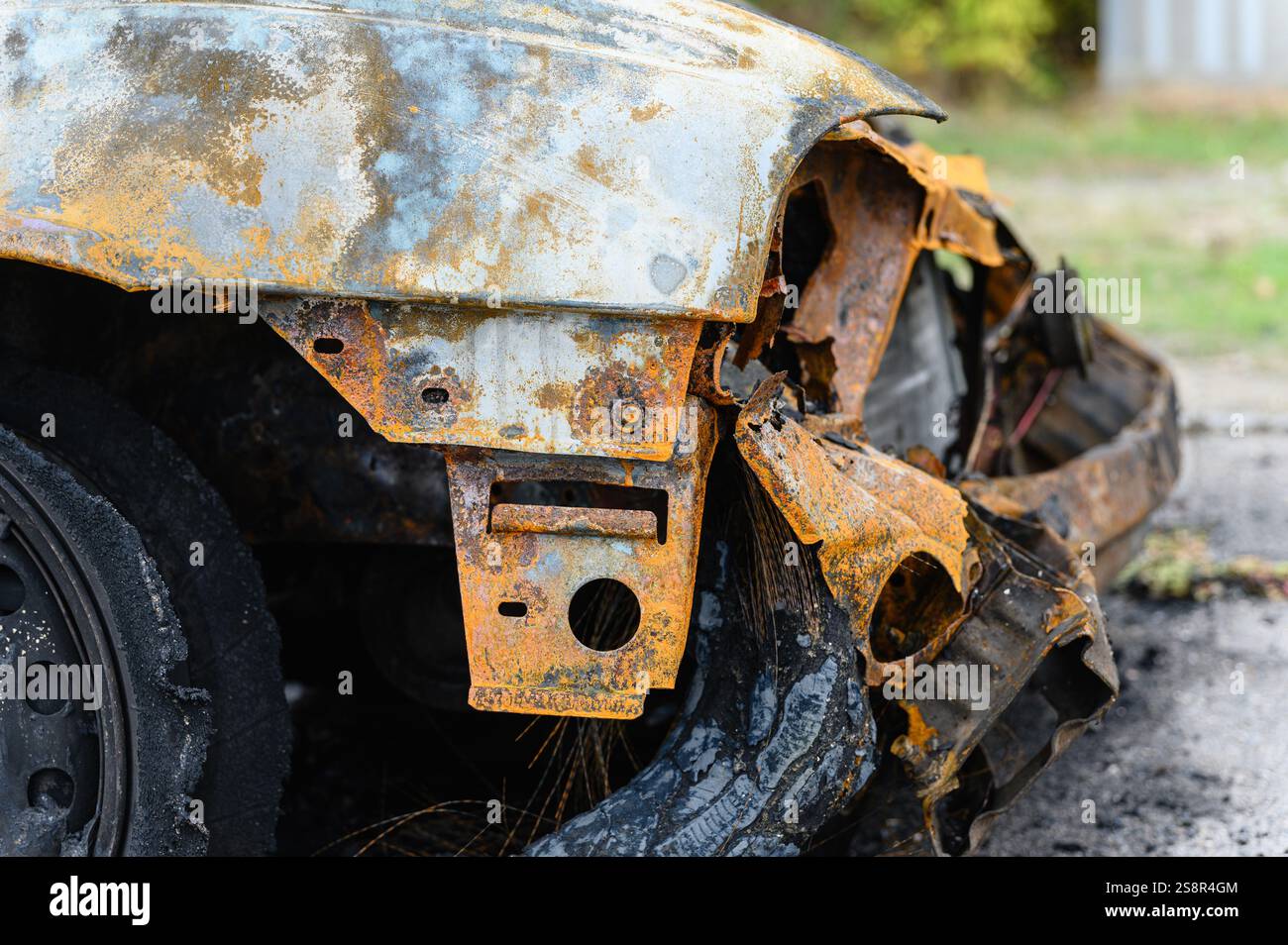 Burnt and destroyed car. Close-up of burnt wheel. Black charred tire ...