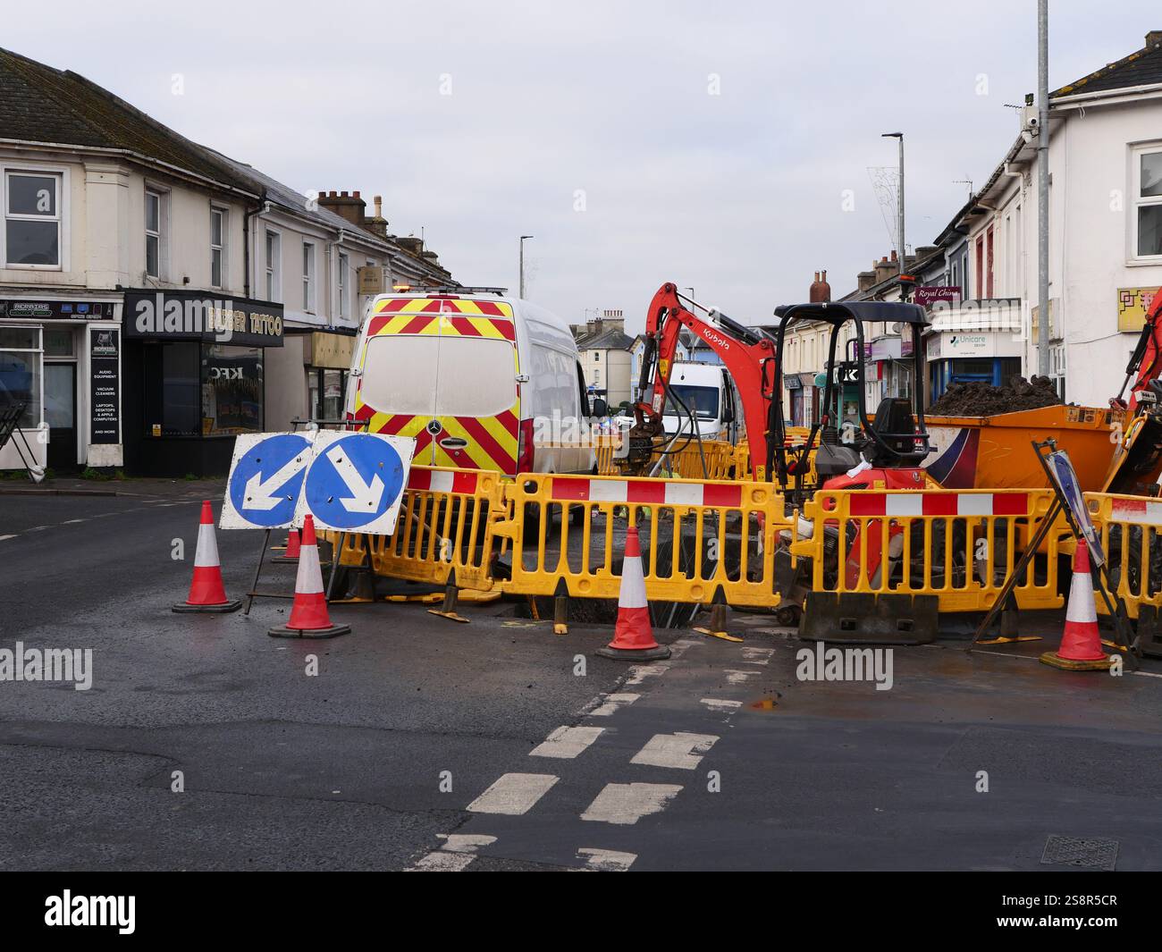 Traffic cones, barriers and blue direction arrow road signs surround ...