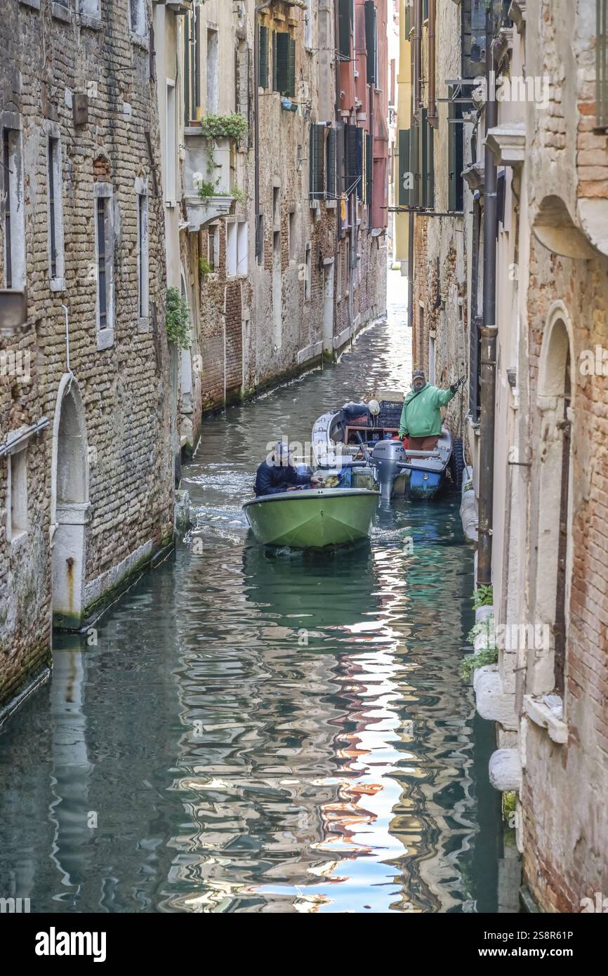 Motorboats, narrows in a small canal in the historic centre, Venice ...