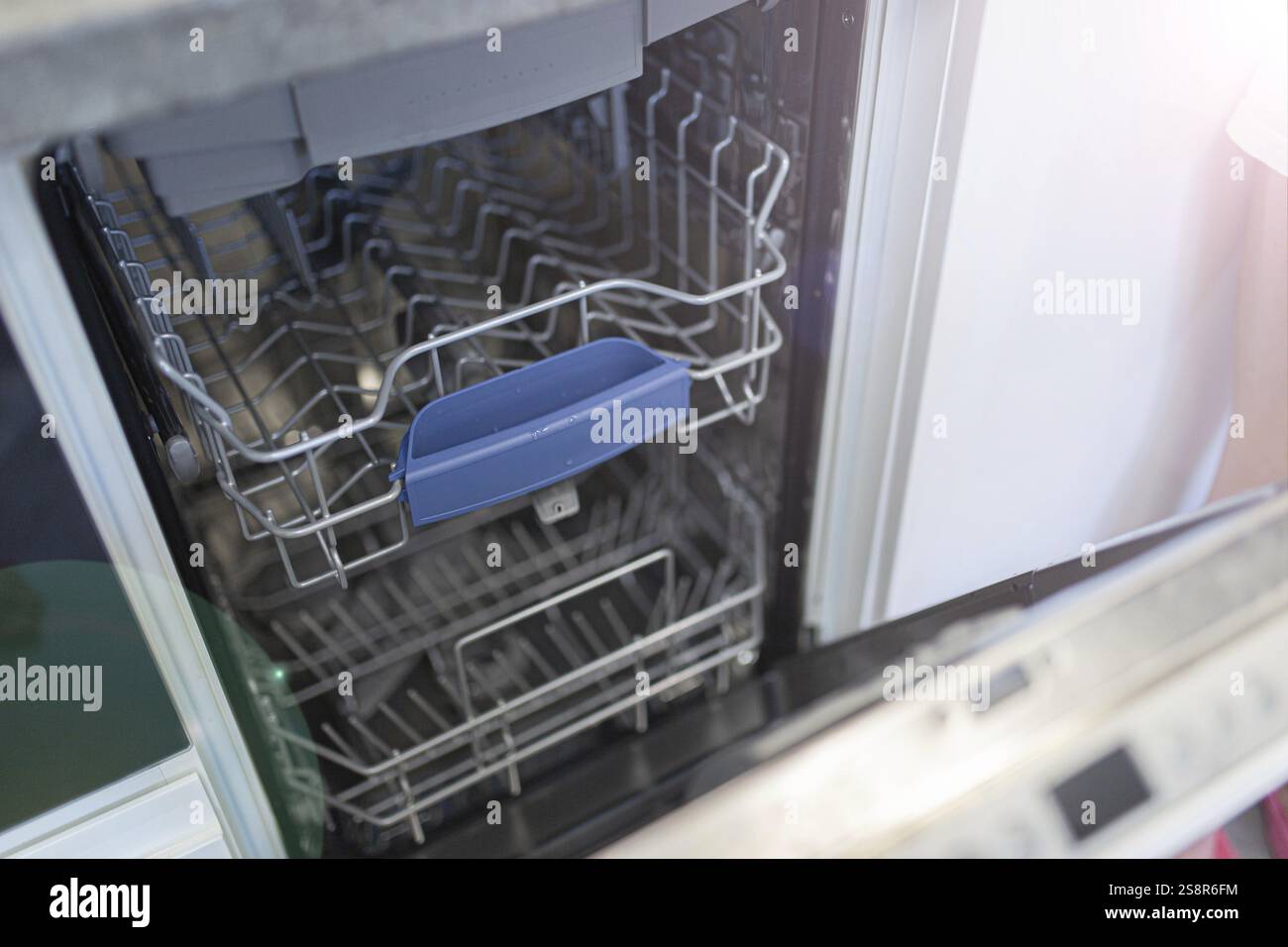 An open dishwasher with an empty rack inside a kitchen Stock Photo - Alamy