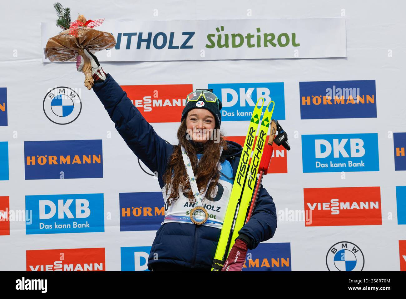 France's Lou Jeanmonnot celebrates on podium after winning a Biathlon ...