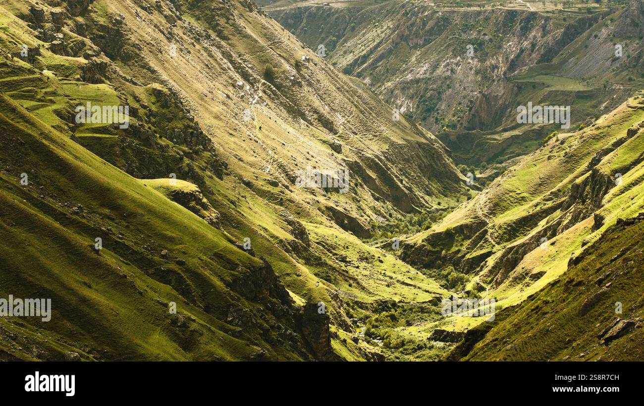 An epic view of a huge mountain rift, the terrain is covered with ...