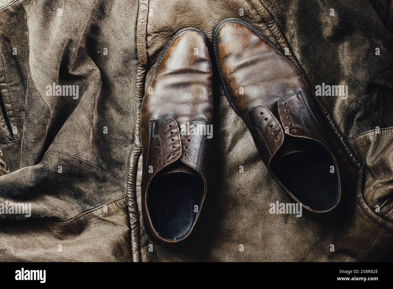 Brown leather shoes paired with a leather jacket, enhancing a vintage ...