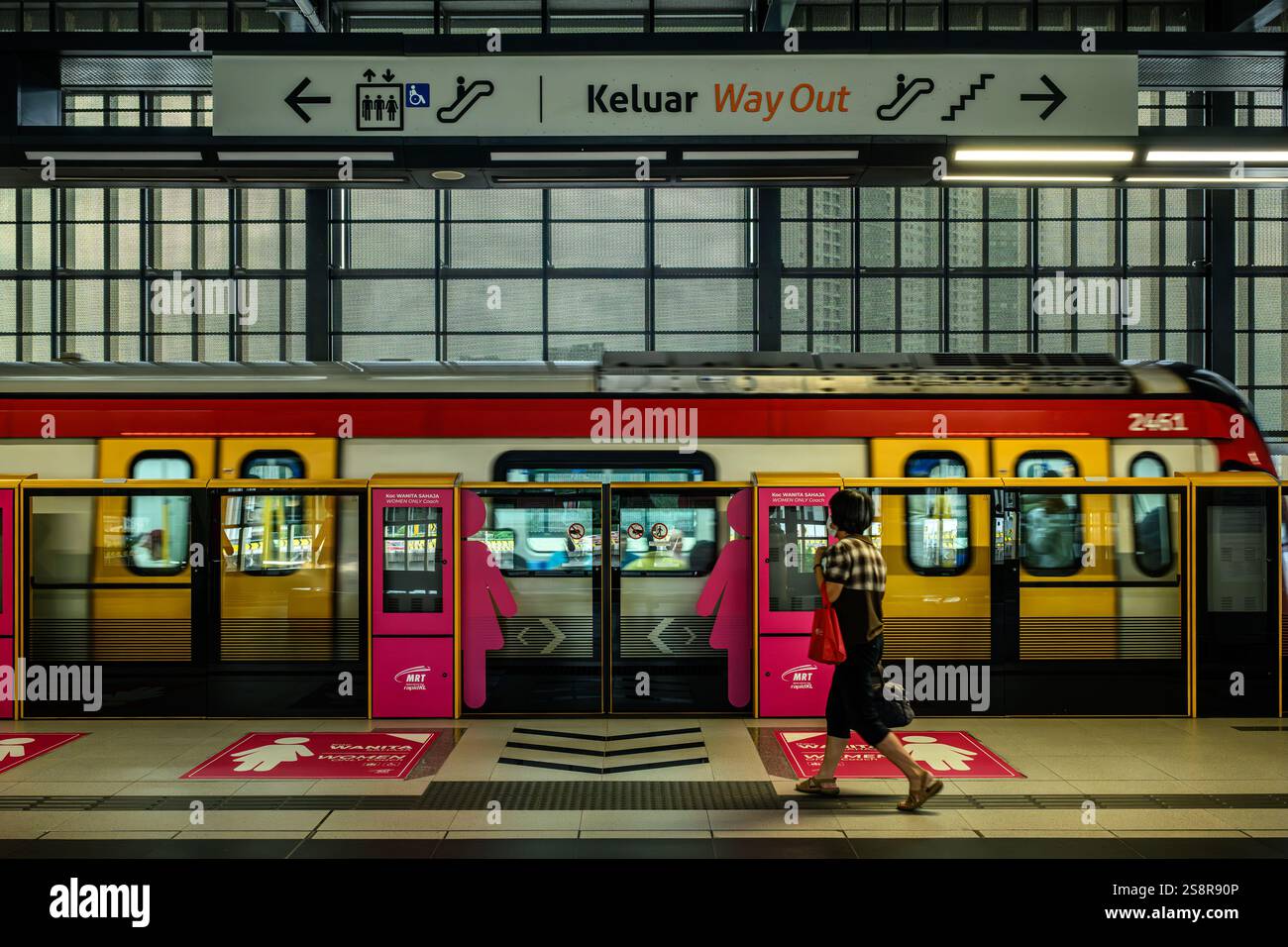 An arriving train with a passenger approaching the gate at Kuchai MRT ...