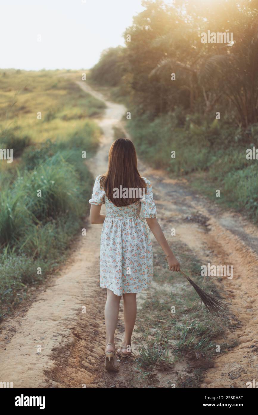 Woman walking dirt path rural setting hi-res stock photography and ...