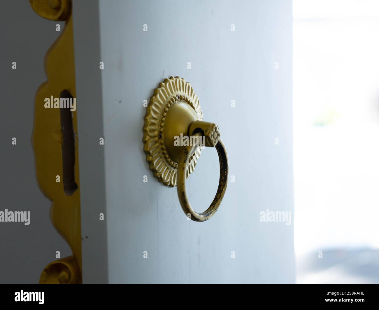A white front door with a gold-colored ring handle as a doorknob Stock ...