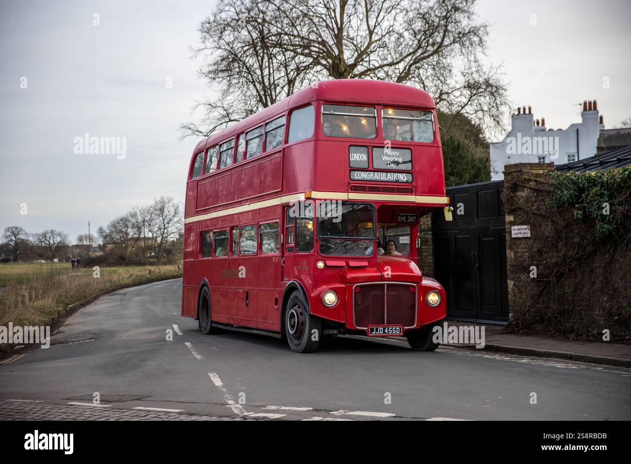 Red Routemaster bus taking wedding guests to a wedding in Wimbledon ...