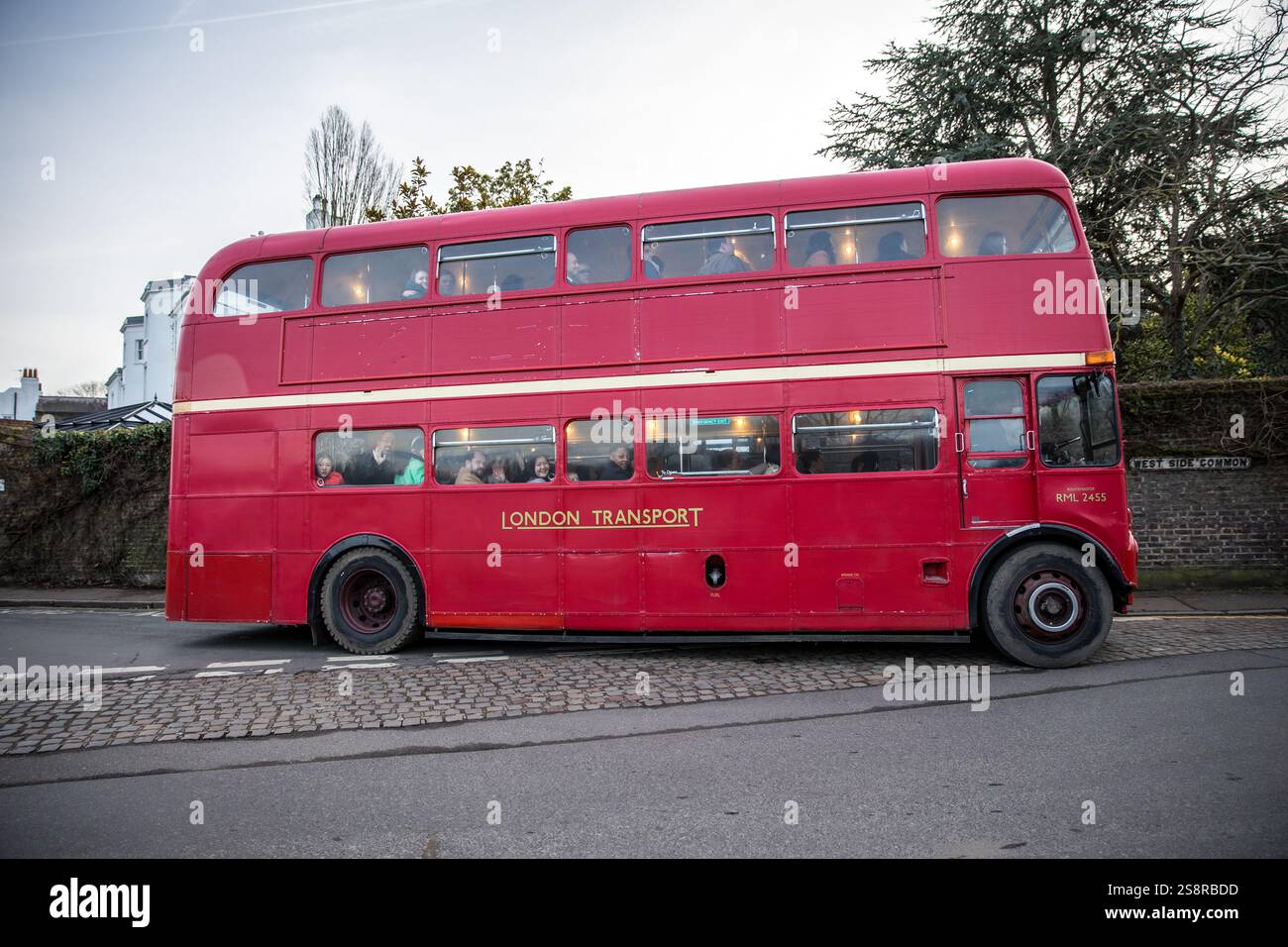 Red Routemaster bus taking wedding guests to a wedding in Wimbledon ...