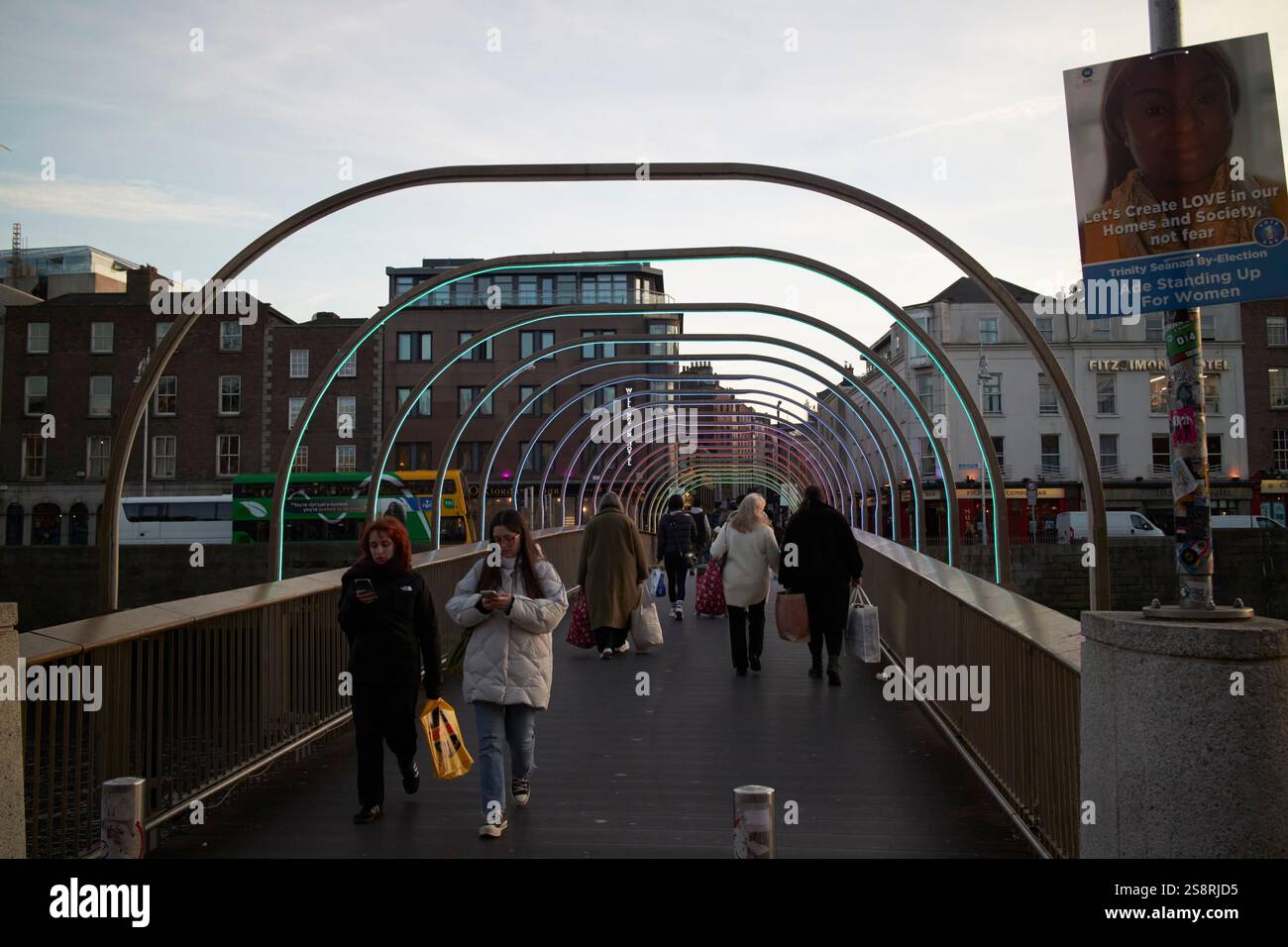 people walk over the millennium bridge pedestrian bridge over the river ...