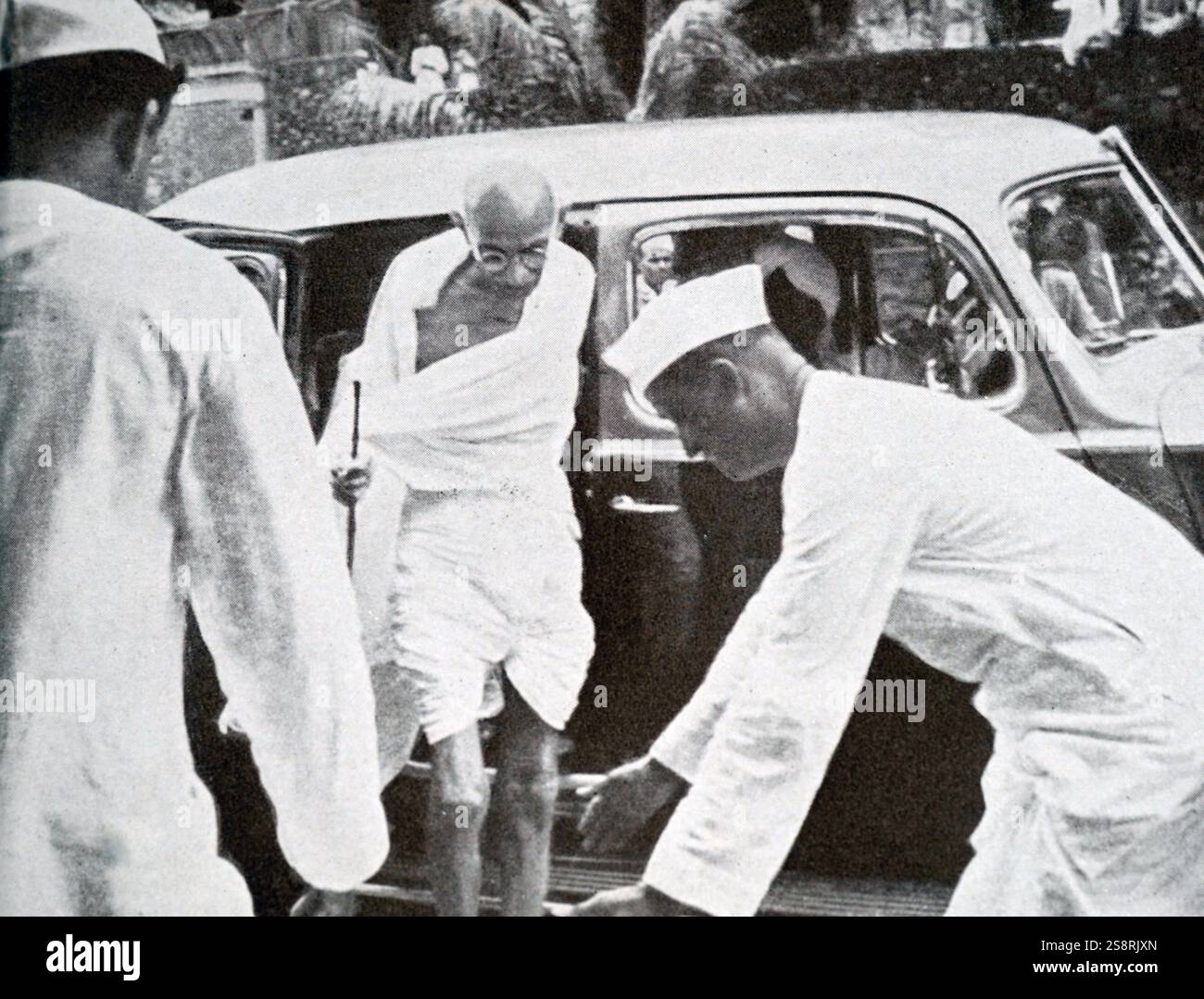 Mohandas Karamchand Gandhi (1869 – 1948) arrives by car for a meeting ...