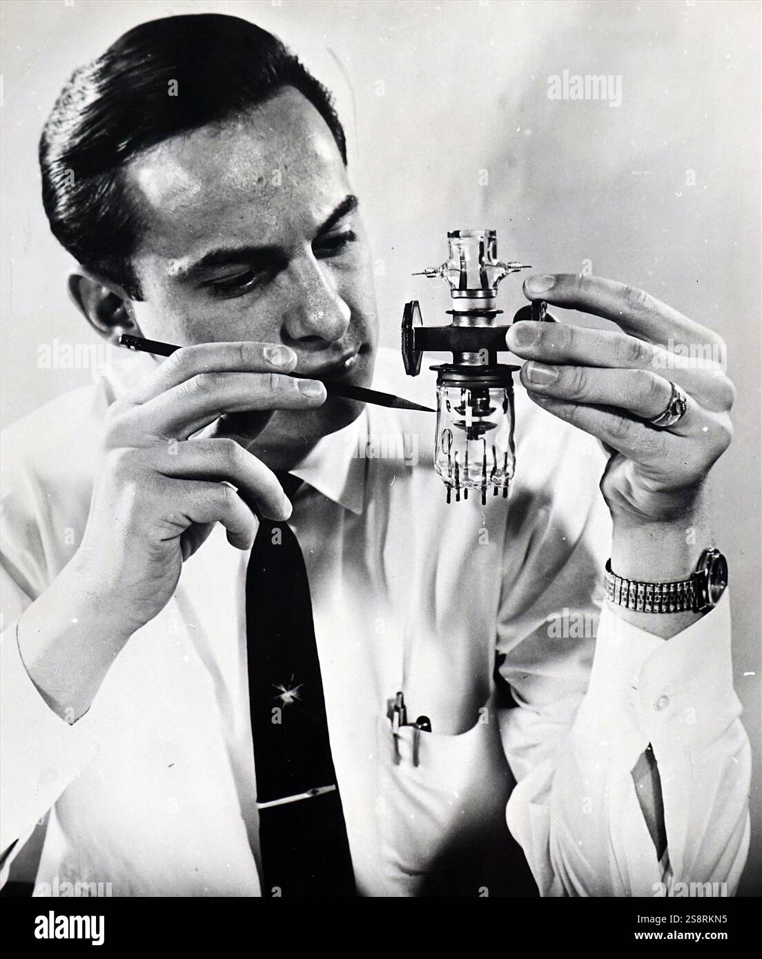 Photograph of a technician holding a laser 'demodulator' used to ...