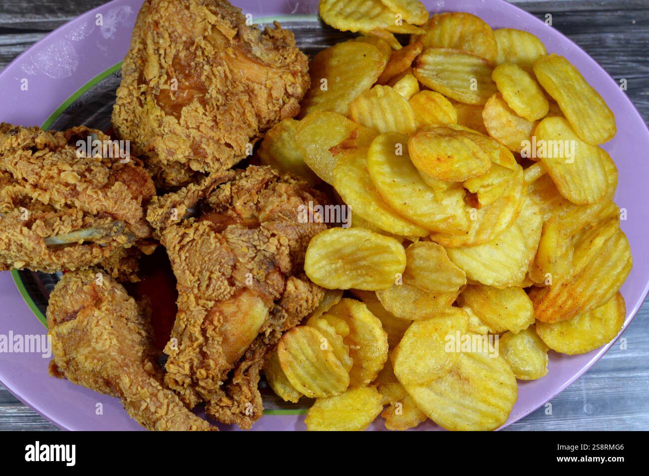 Broasted chicken meal with fried potato chips, a broast chicken pieces ...