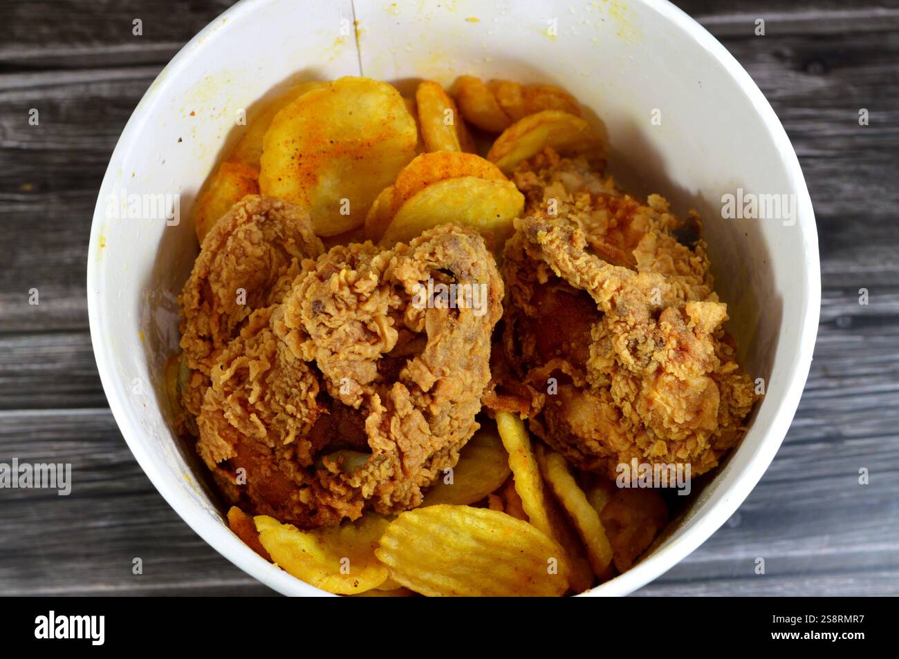 Broasted chicken meal with fried potato chips, a broast chicken pieces ...
