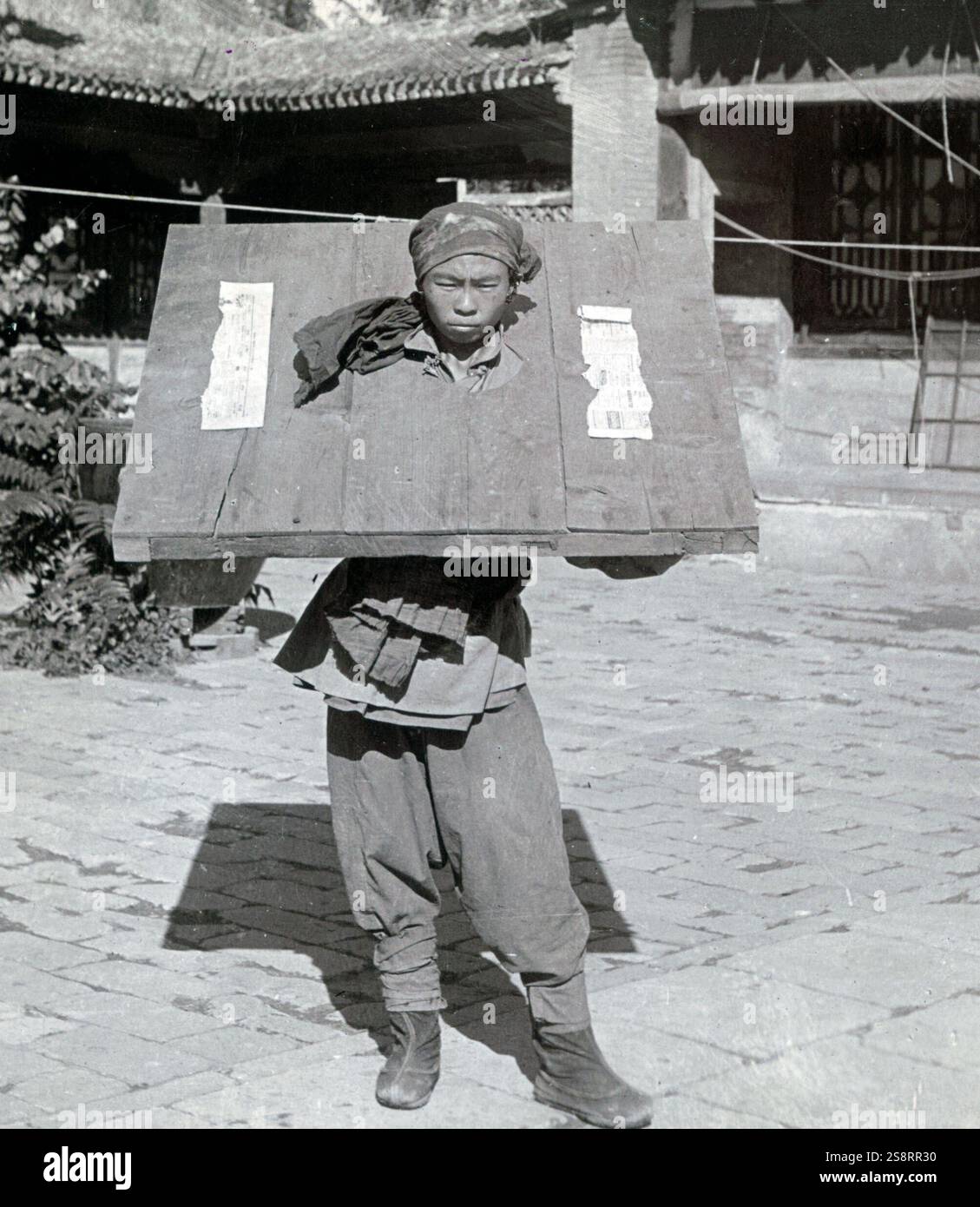Boxer rebel wearing a prisoner yoke during the The Boxer Rebellion ...