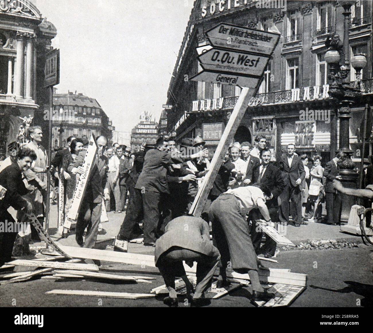 Parisians taking down German signs in Paris after the end of World War ...