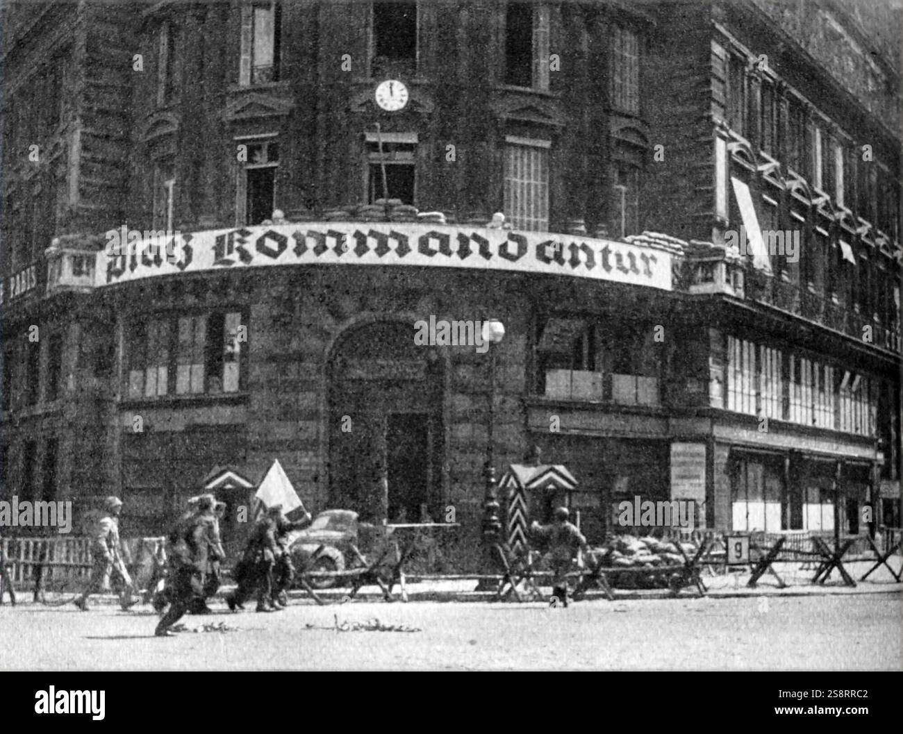 German soldiers wave the white flag of surrender on the streets of ...