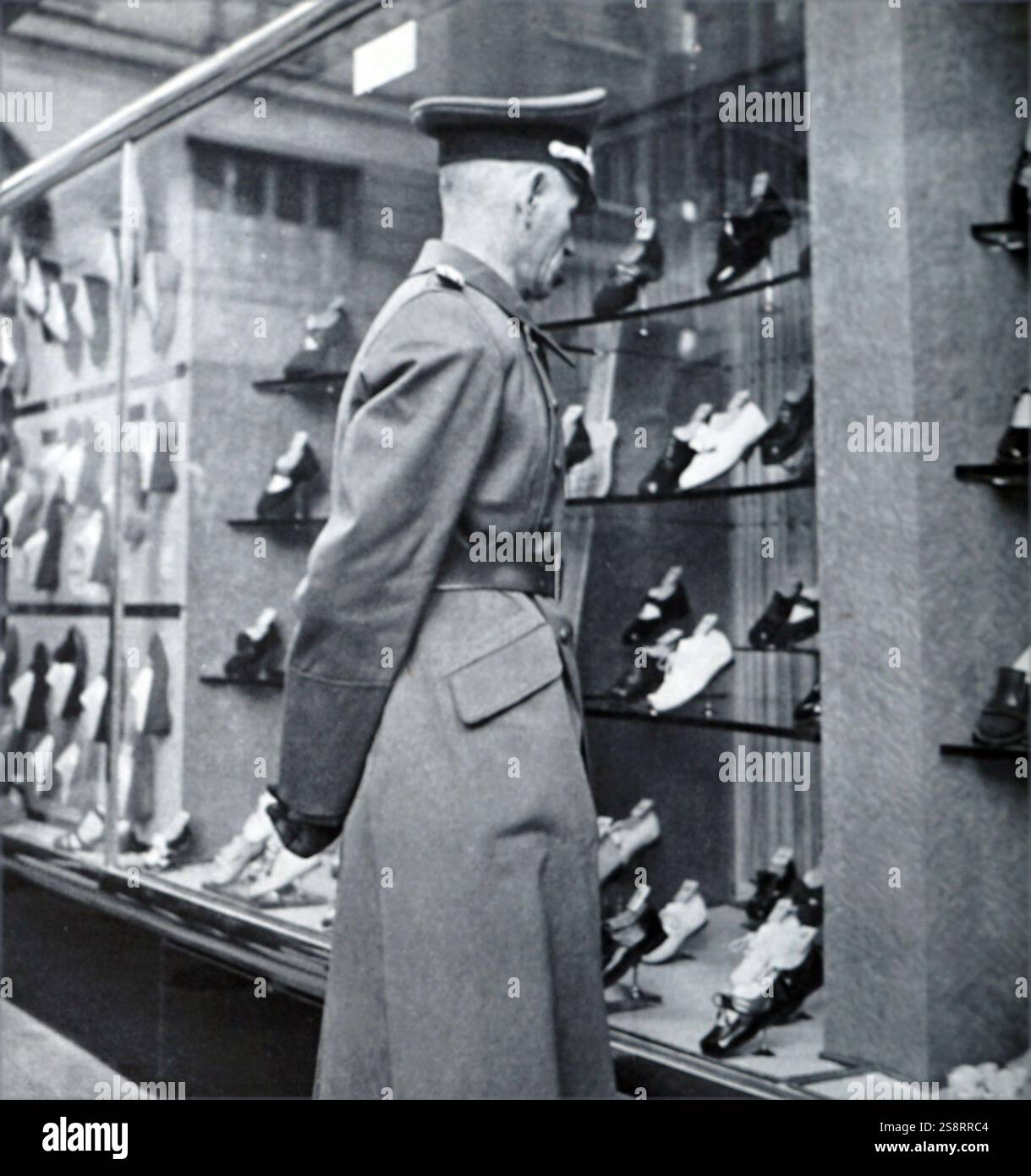 A German officer looks at the empty shops in Paris during World War II ...