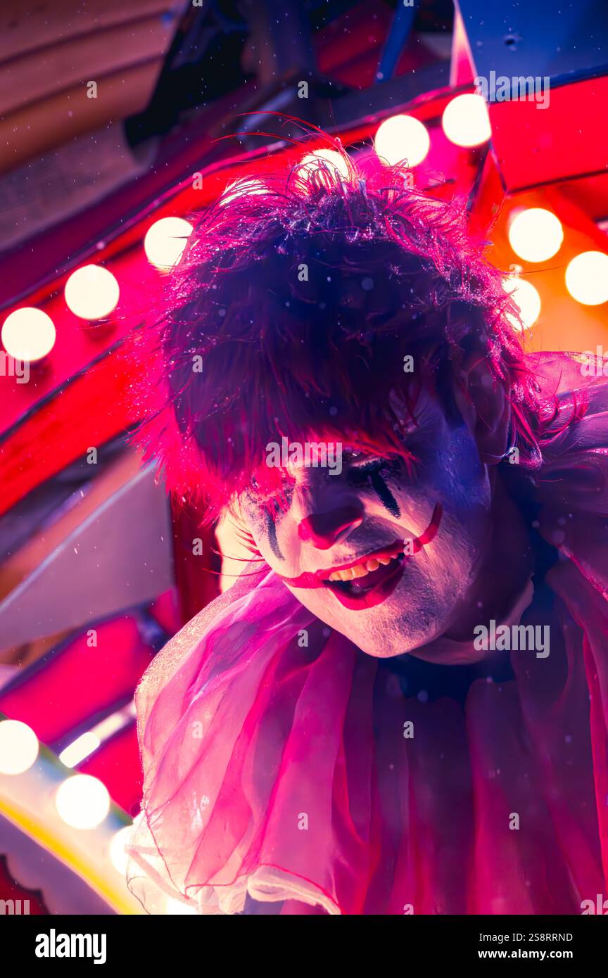 Close-up picture of a scary carnival performer dressed as a clown in ...