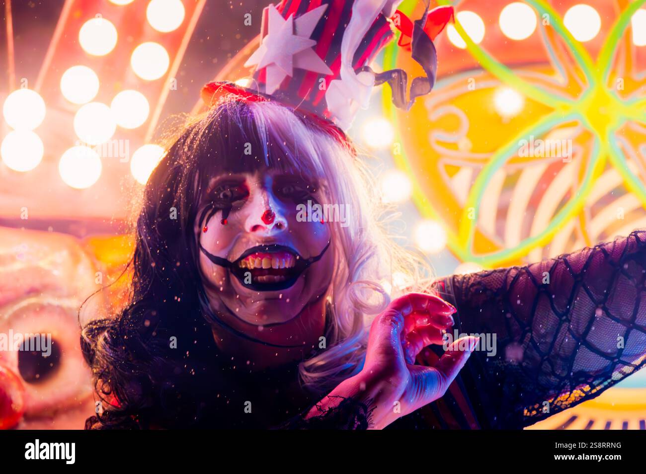 Close-up photo of carnival performer in creepy clown makeup with scary ...