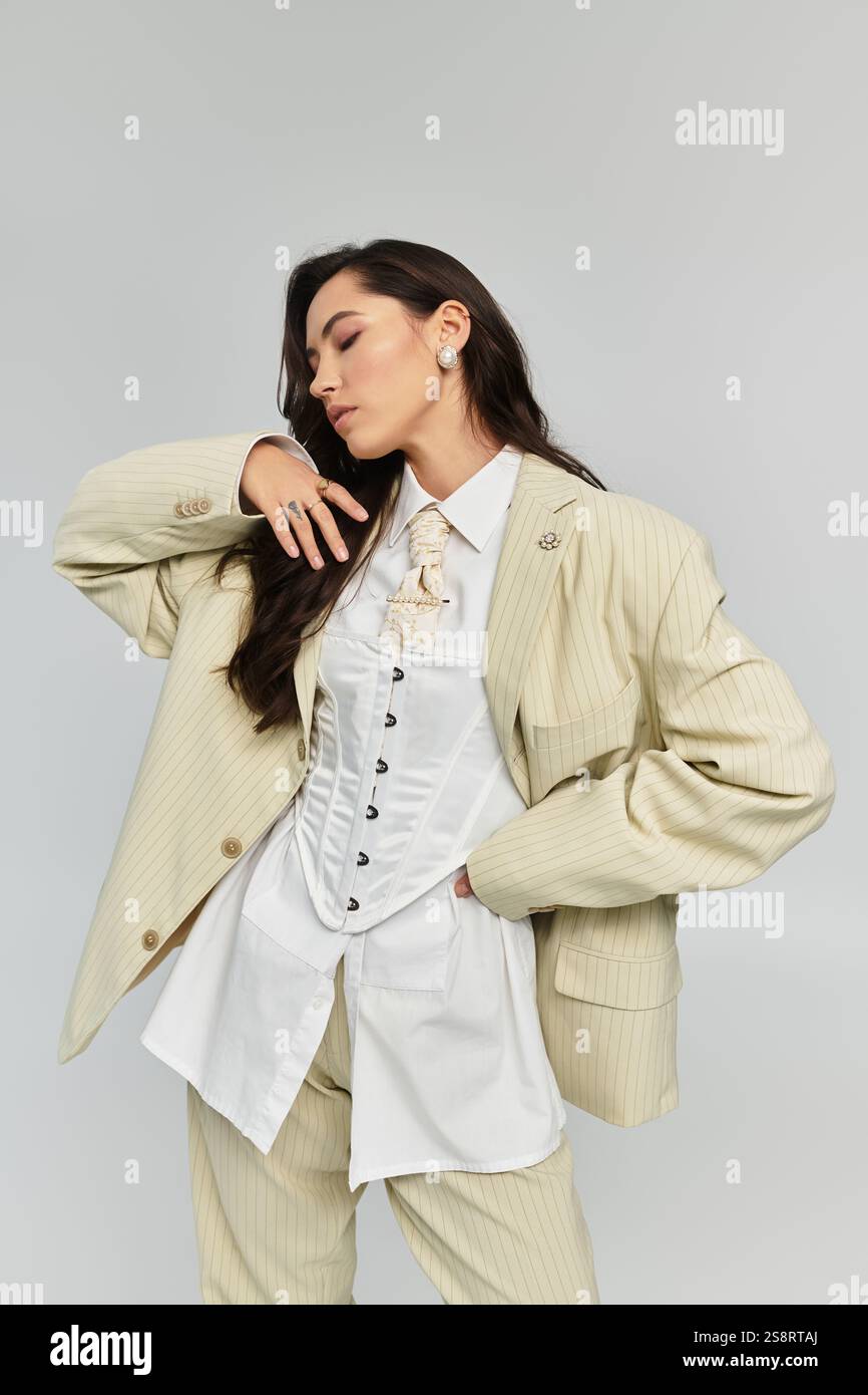 A beautiful, stylish woman confidently poses in a chic beige ensemble ...