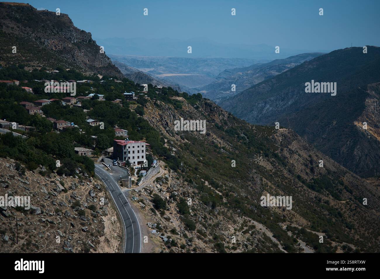view of the mountain road, city and mountains from the funicular near ...