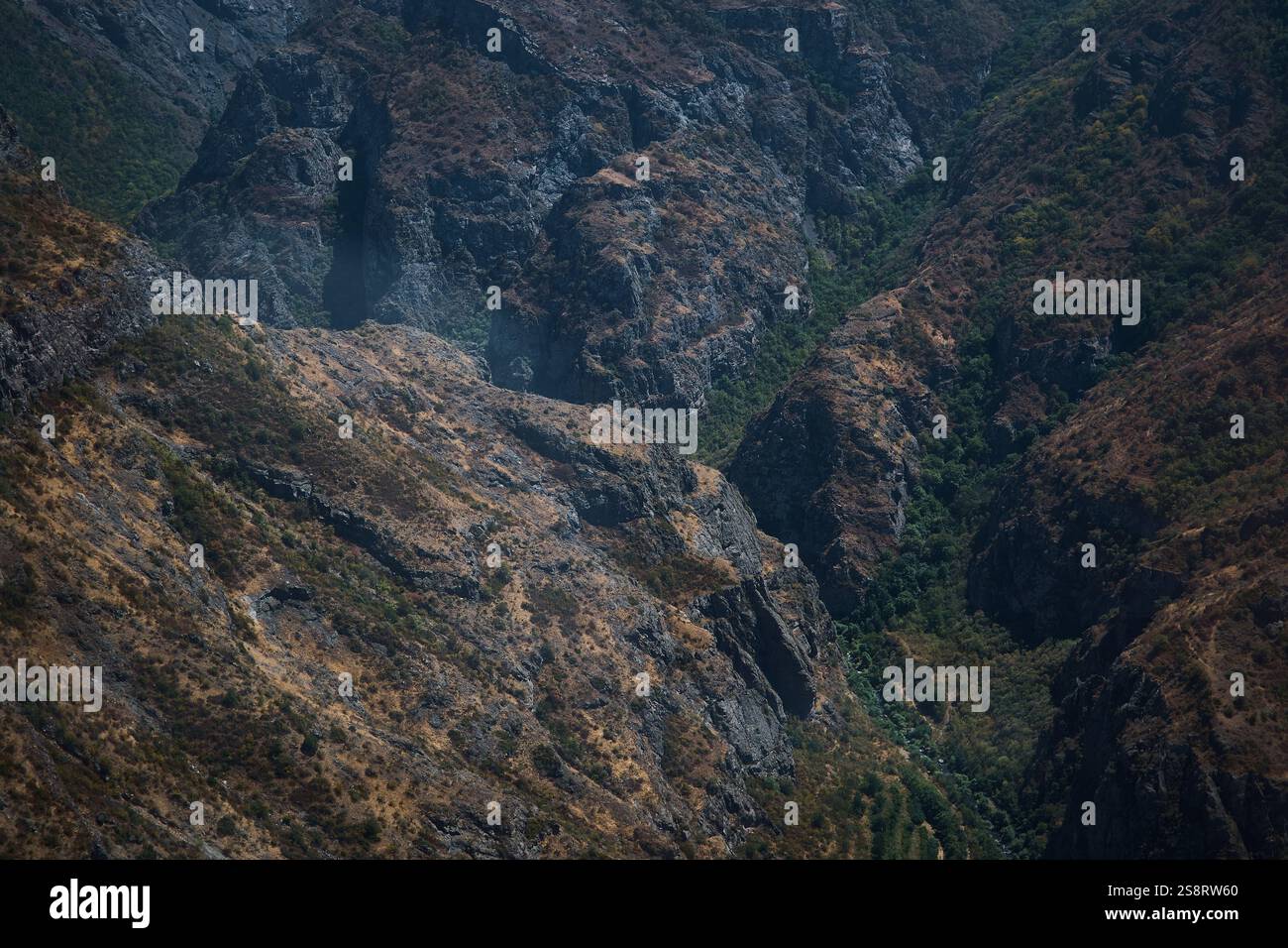 view of the mountain road, city and mountains from the funicular near ...