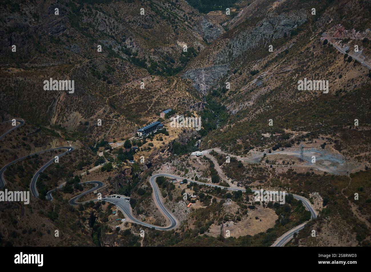 view of the mountain road, city and mountains from the funicular near ...