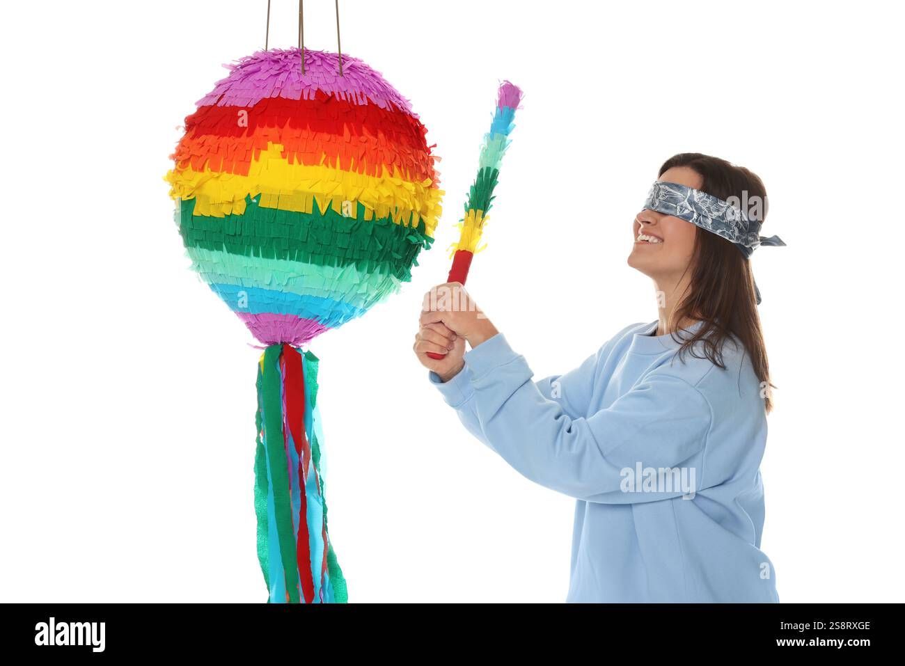 Woman with tied eyes breaking pinata on white background Stock Photo ...