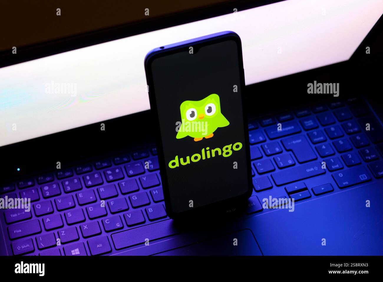 In this photo illustration, the Duolingo logo is seen displayed on a ...