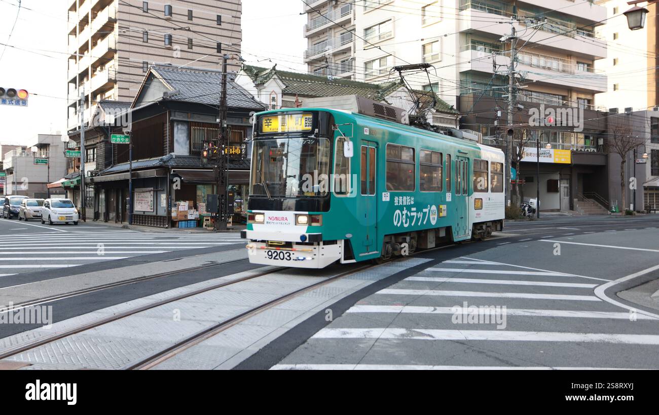 Kumamoto, Japan -January 15 2025:the tram pass through the old coffee ...