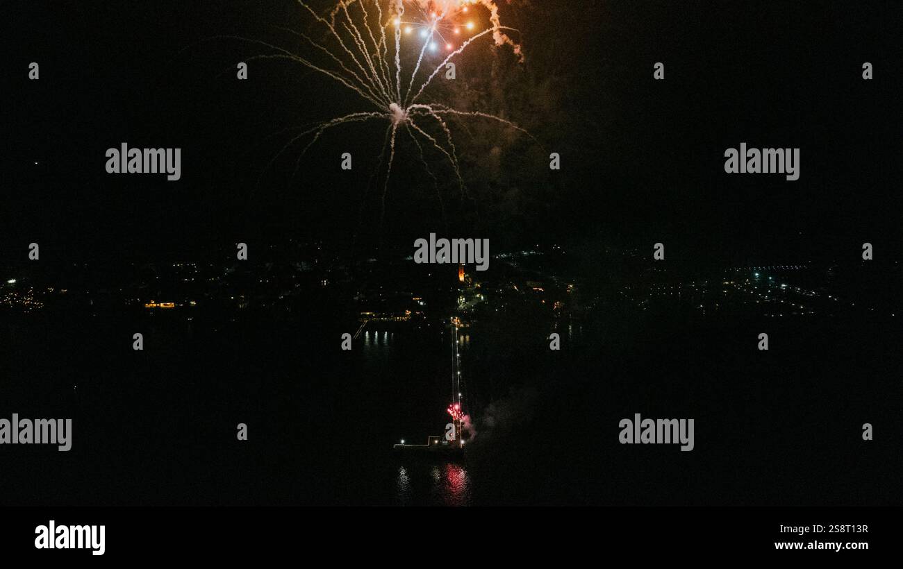 A fireworks display is lit up in the night sky. The fireworks are in ...