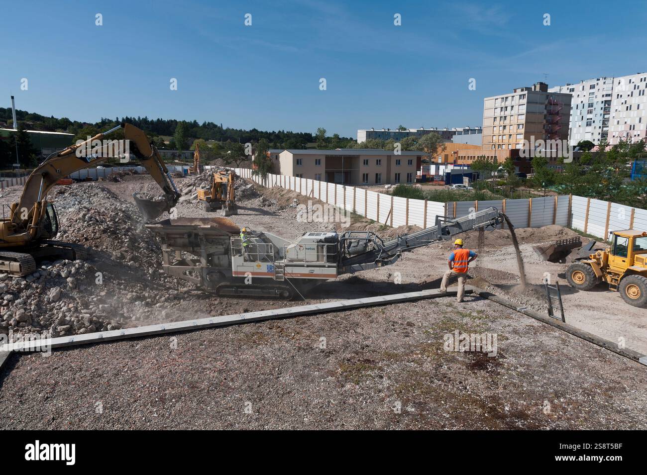 Mobile crusher in action to finish pulverizing the remains of a ...