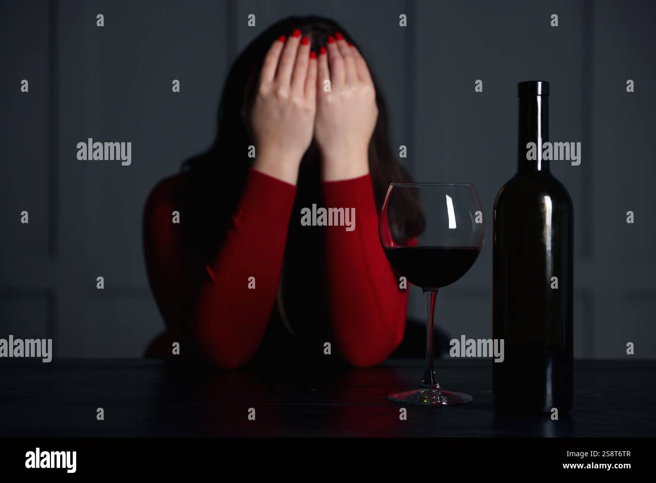 Alcohol addiction. Woman covering her face at wooden table indoors ...