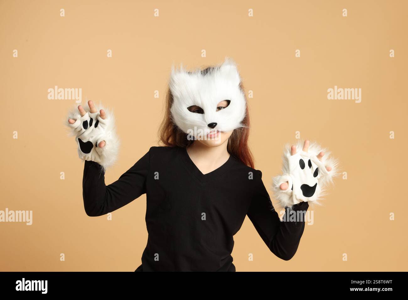 Quadrobics. Girl wearing cat mask and gloves on beige background Stock ...