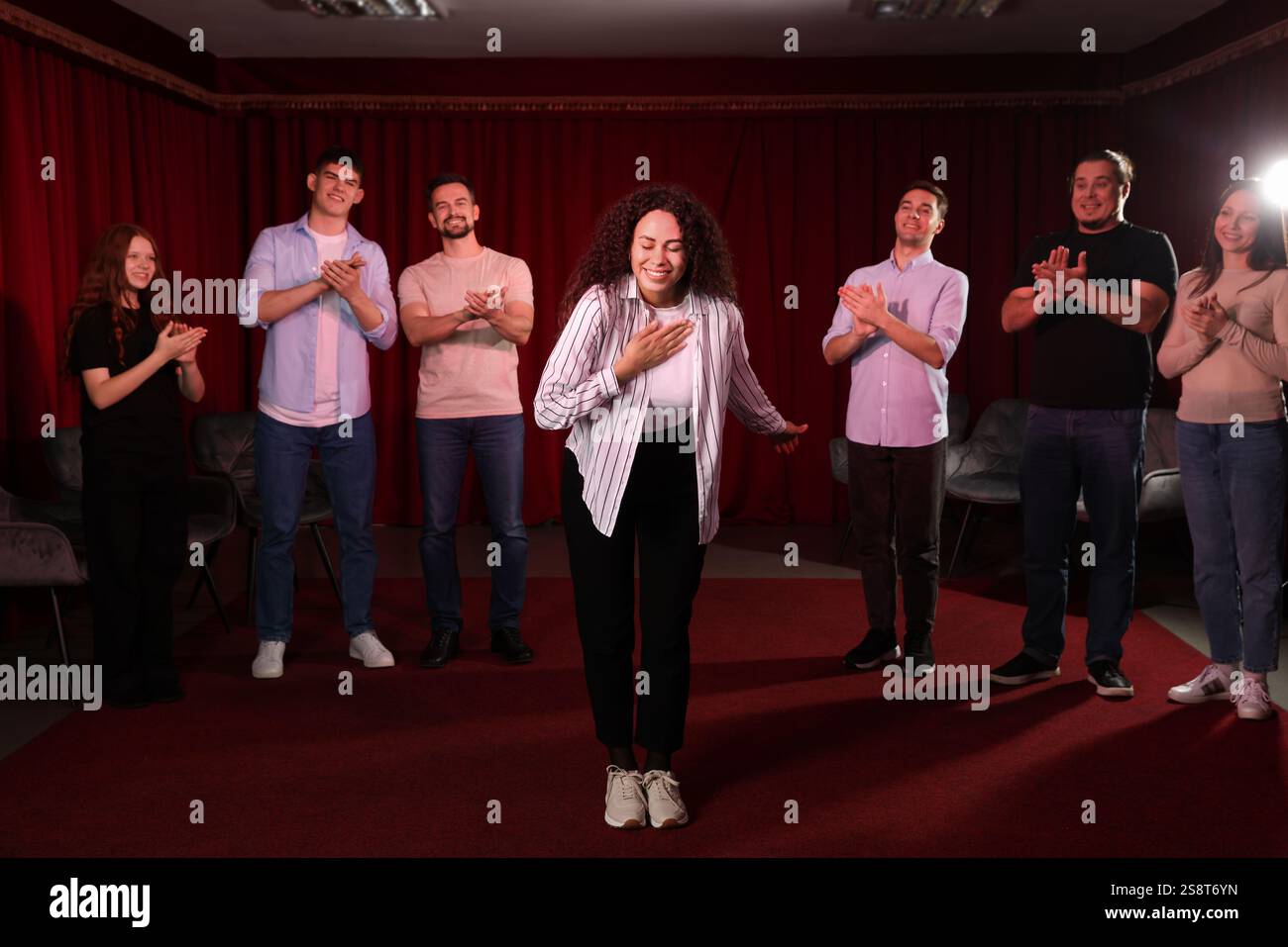 Professional actors bowing on stage in theatre Stock Photo - Alamy