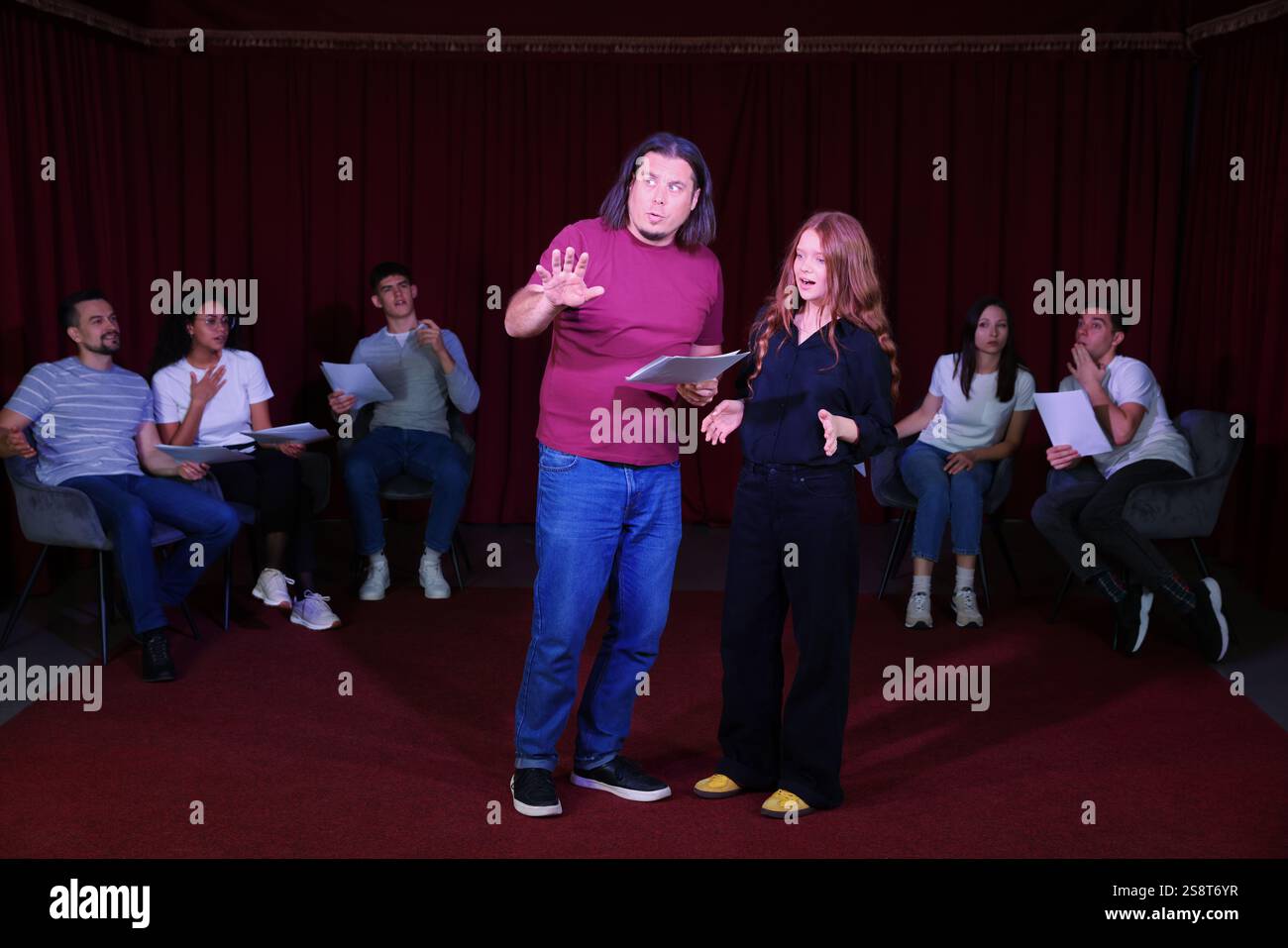 Professional actors with their scripts rehearsing in theatre Stock ...