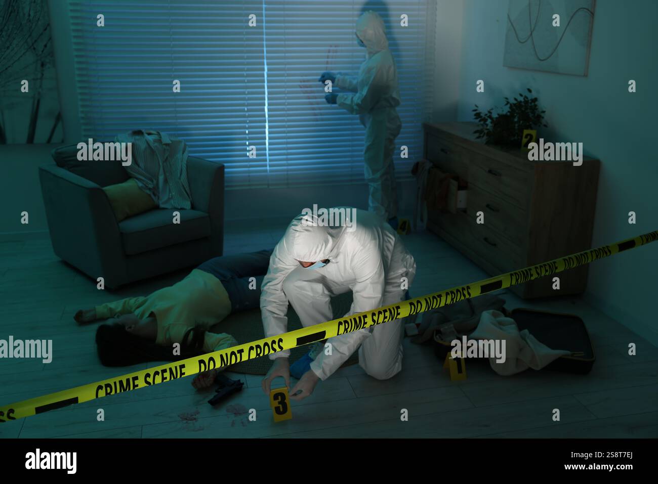 Forensic experts working at crime scene with dead woman's body indoors ...