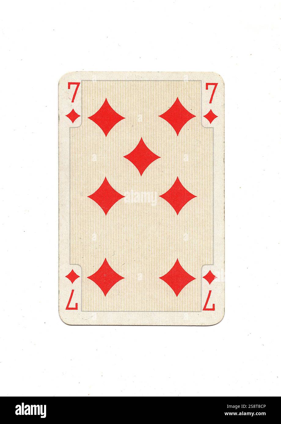 An antique seven of diamonds playing card isolated on a white ...